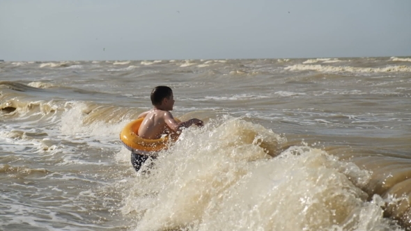 Young Boy Playing in the Wave, Stock Footage | VideoHive