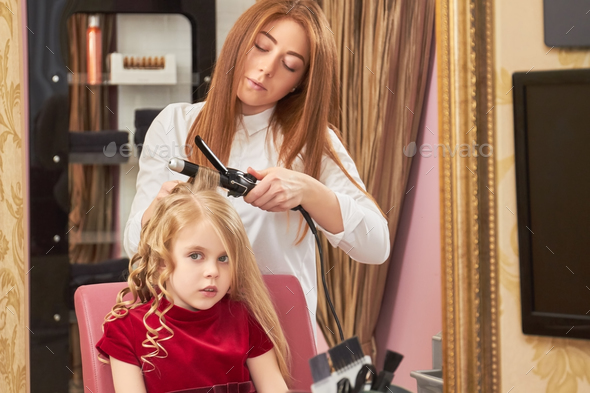 Cute child getting hair done Stock Photo by stockfilmstudio | PhotoDune