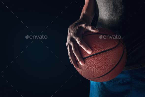 The hands of a basketball player with ball Stock Photo by master1305