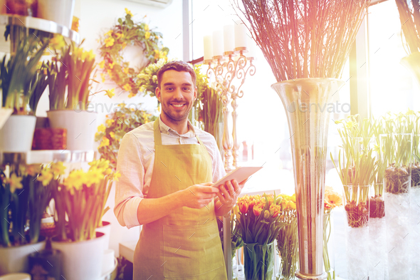 man with tablet pc computer at flower shop - Stock Image - Everypixel