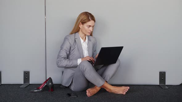 Tired Business Woman Without Shoes Feels Pain in Legs Using Laptop ...