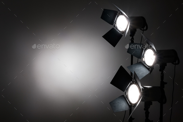 Several reflectors on the black background in photo studio. Stock Photo ...