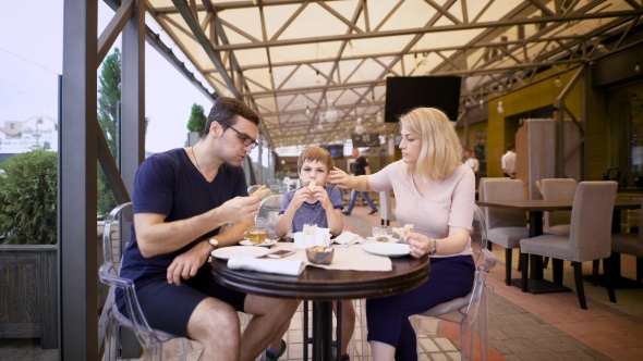 Image of a Happy Family and Their Son at the Cafe. Loving Couple with ...