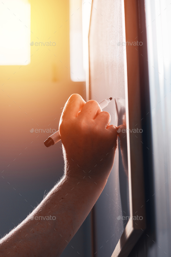 Female student writing on classroom whiteboard Stock Photo by ...