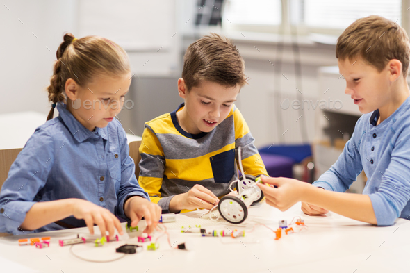 happy children building robots at robotics school Stock Photo by dolgachov