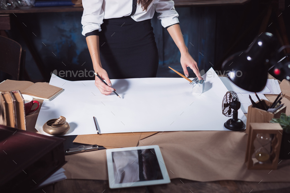 Architect working on drawing table in office Stock Photo by master1305
