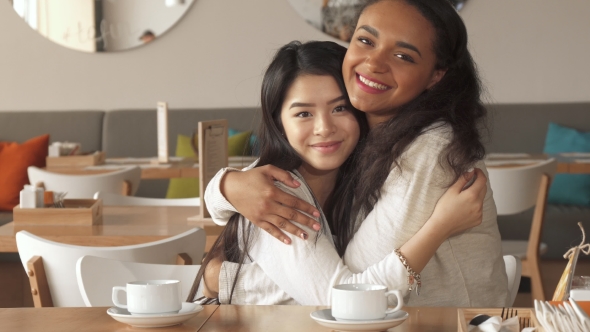 Two Girls Hug at the Cafe, Stock Footage | VideoHive