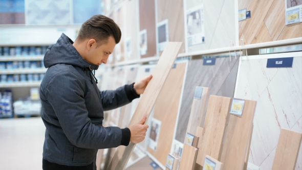 Handsome Man Is Choosing Building Material in Construction Shop for a ...