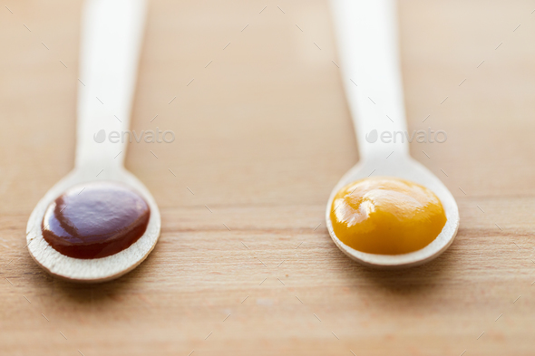 vegetable or fruit puree or baby food in spoons Stock Photo by dolgachov