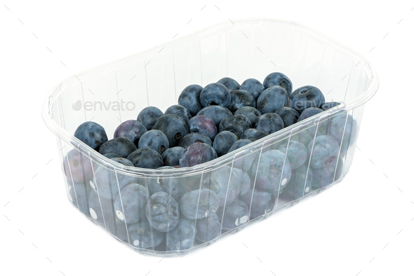 Blueberries in a plastic container on white background Stock Photo by ...