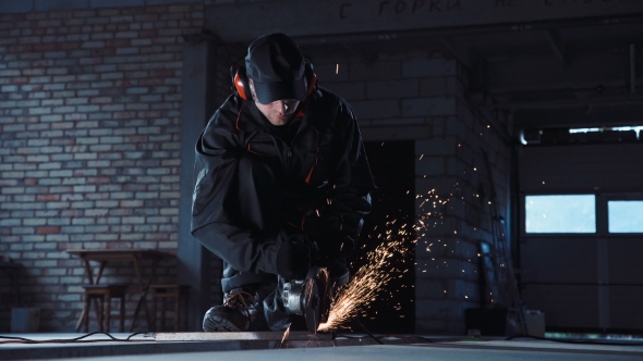 Man Cutting with Grinder in Hangar, Stock Footage | VideoHive