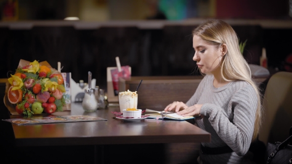 A Young and Pretty Woman Is Eating Lunch in a Restaurant, a Lady Eating ...
