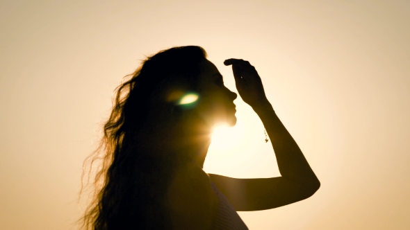 Woman Posing in Back Light on Sky Background., Stock Footage | VideoHive