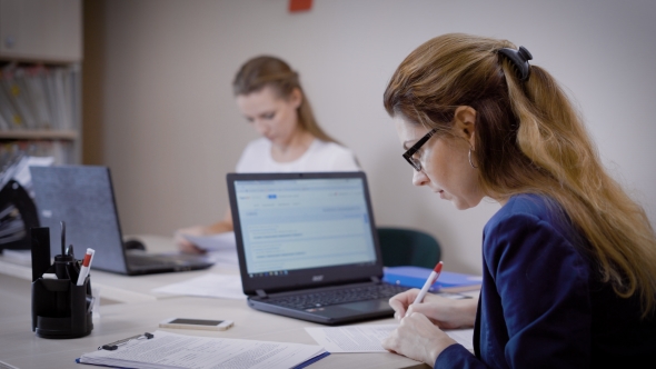 People Concentrated on Working with Paper at Table in Office, Stock Footage