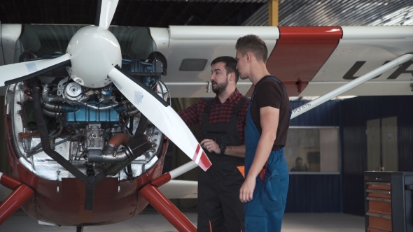 Two Flight Mechanics Doing a Pre Flight Check, Stock Footage | VideoHive