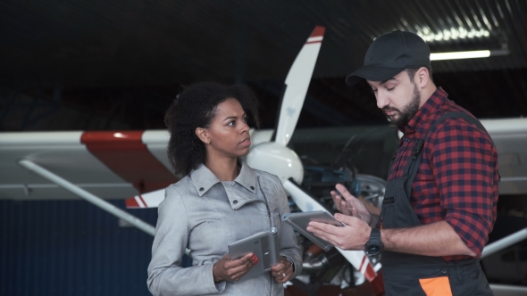 Pilot and Mechanic Discussing Aircraft Repairs, Stock Footage | VideoHive