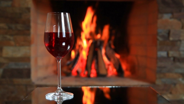 Wineglass with Red Wine Near a Fireplace, Stock Footage | VideoHive