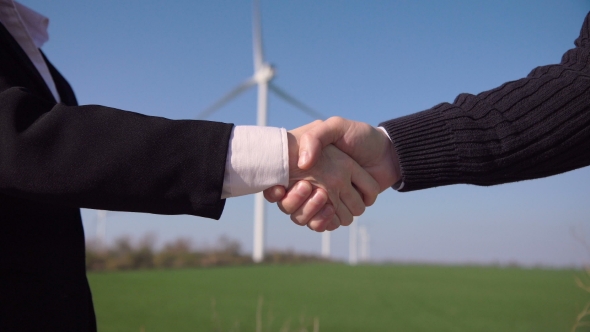 Business Handshake Against Wind Turbines, Stock Footage | VideoHive