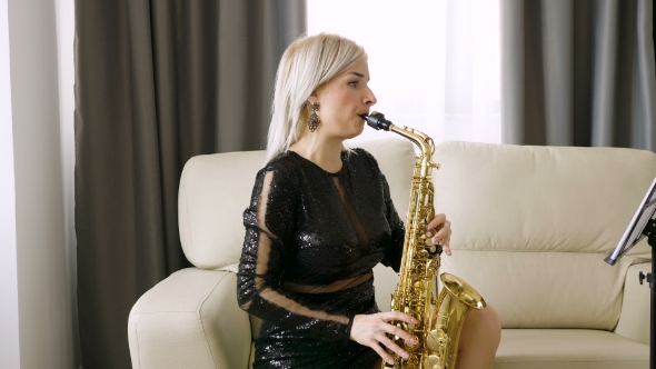 Jazz Saxophone Player Performing on the Sax in the Living Room, Stock ...