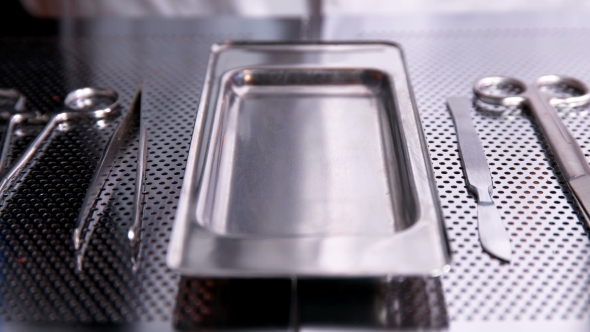 the Surgeon Throws the Bullet on the Tray After Surgery, Stock Footage