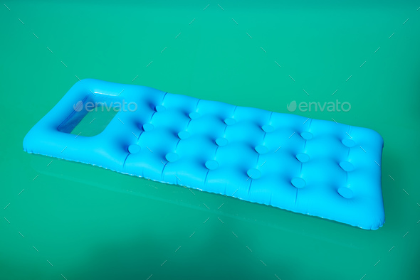 Inflatable mattress floating on swimming pool surface Stock Photo by ...