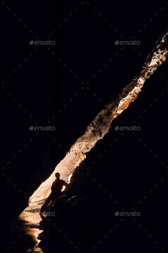 Spelunker, geologist exploring underground cave gallery Stock Photo by ...