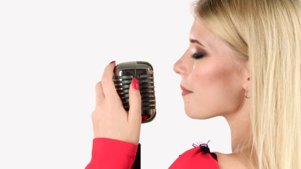 Singer Sings in a Retro Microphone. White Background. Side View., Stock ...