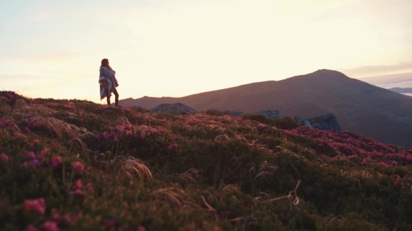Rotation View of a Stylish Woman Standing on a Flowered Meadow, Bright ...