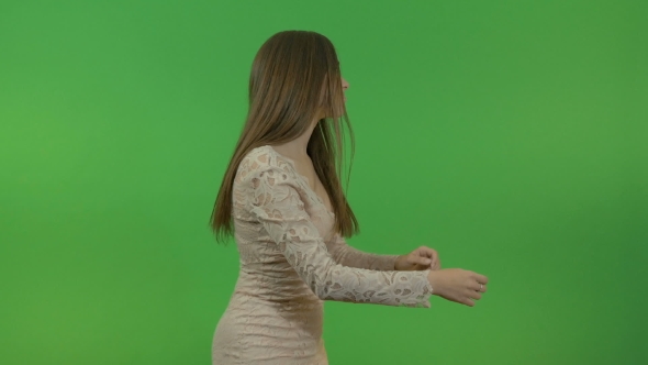 Young Girl Turns on a Green Wall Background., Stock Footage | VideoHive