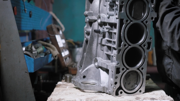 Shot of a Automechanic Tightening Bolt on Engine Block, Stock Footage