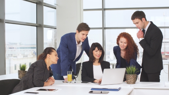 Manager with his business team sitting discussing a project with them ...