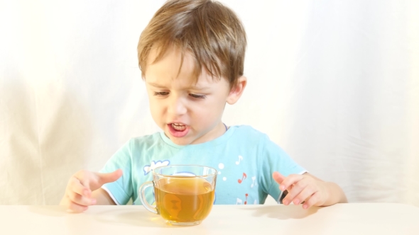 The Child Refuses to Drink Tea from a Glass Cup, Stock Footage | VideoHive