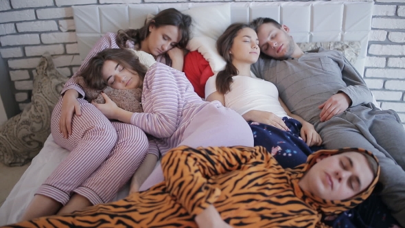 Friends Tired After the Party Sleeping Together on the Bed, Stock Footage