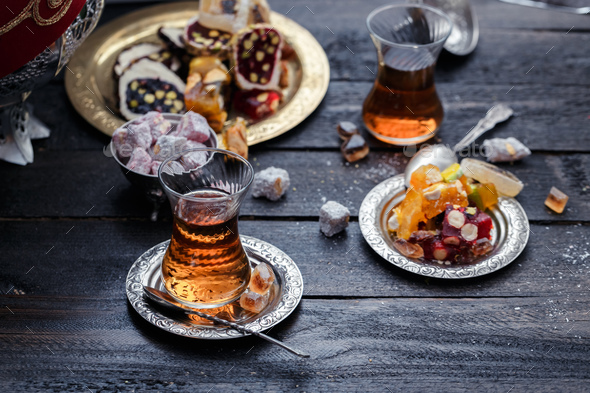 Cups of Turkish tea with oriental sweets on rustic wood Stock Photo by ...