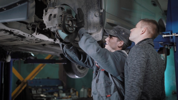 Car Mechanic Showing Problem To Customer, Stock Footage | VideoHive