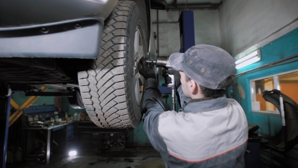 Car Mechanic Removing Wheel From Car, Stock Footage | VideoHive