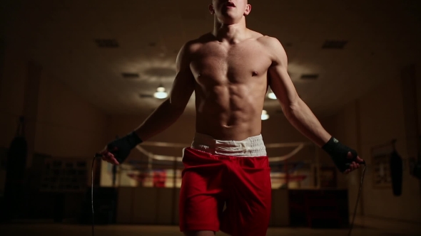 Boxer Warming Up Before a Workout Performs a Jumping Rope on the ...