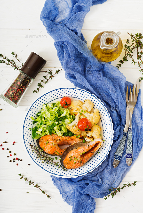 Dietary menu. Baked salmon steak with cauliflower, tomatoes and herbs ...