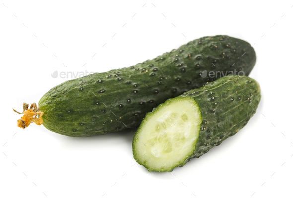 Green cucumber whole cut in half, isolated Stock Photo by Prostock-studio