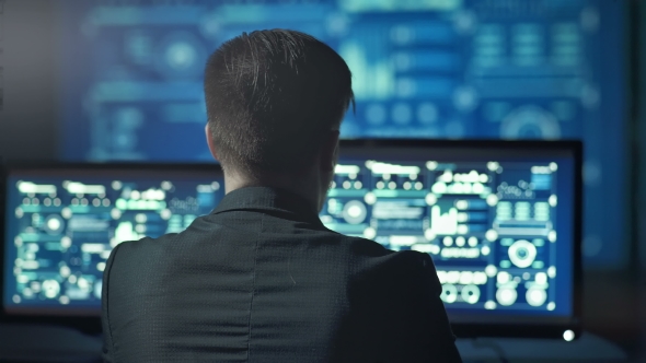 Back View of Programmer Working on Computer in Dark Digital Office ...