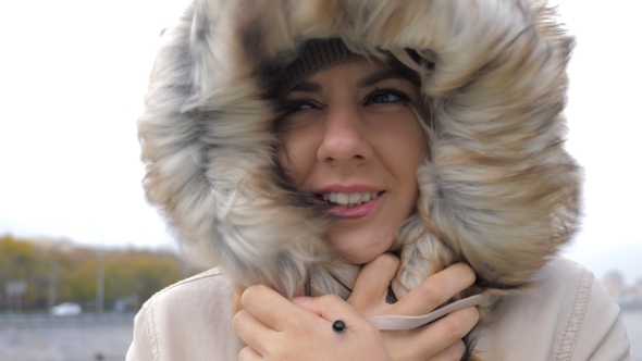 Woman in a Jacket with Hood Closed from the Strong Cold Wind, Stock Footage