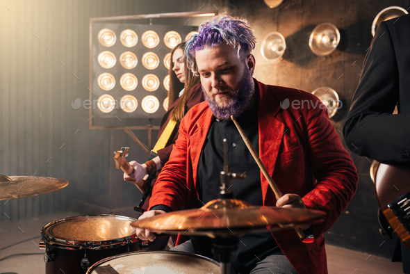 Drummer in red suit on the stage, rock band Stock Photo by NomadSoul1