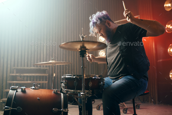 Bearded drummer with colorful hair on the stage Stock Photo by NomadSoul1