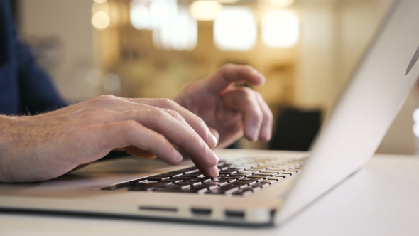 Man Looks at Email Diagram and Chart with and Typing Text on the Laptop ...