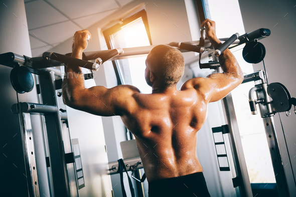 Strong man exercising in a gym. Stock Photo by photocreo | PhotoDune