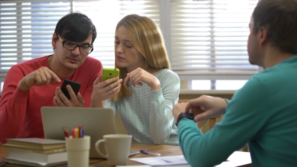 Young People Using Different Electronic Gadgets in the Office, Stock ...