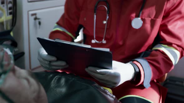 Crop Paramedic Filling Papers in Ambulance, Stock Footage | VideoHive