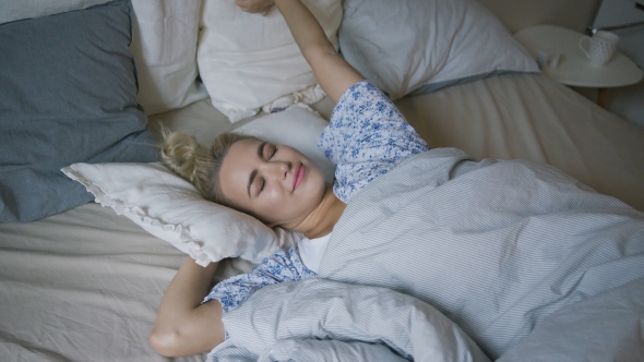 Woman Stretching Arms in Bed, Stock Footage | VideoHive