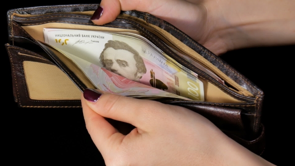 Female Hands Out Cash Dollars From Purse Dollar and Hryvnia Black ...