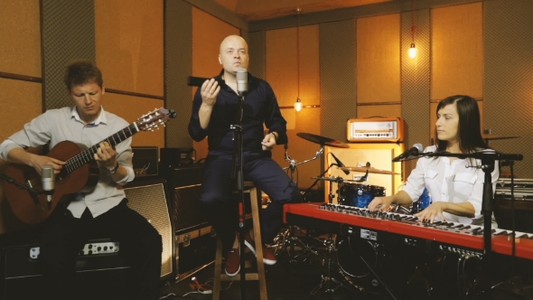 Three Musicians Playing in Studio, Stock Footage | VideoHive